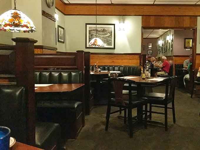 Green booths and wood paneling create the perfect backdrop for serious rib consumption and family memories.