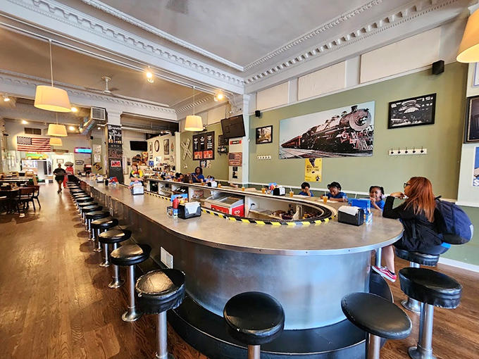 That counter setup with the train tracks is like something out of a kid's wildest dream, except the food is actually good.