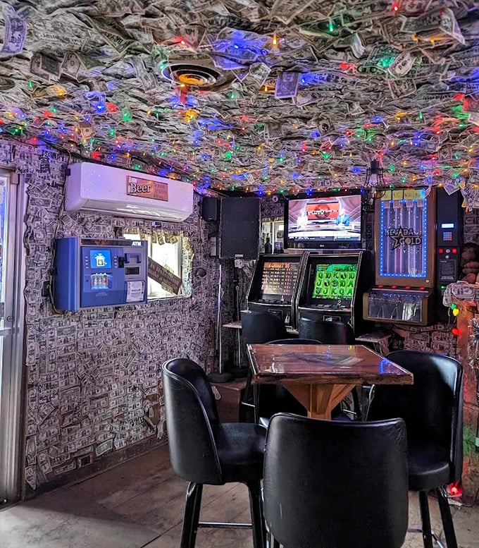 The famous dollar-covered interior glows with colorful Christmas lights, creating a festive atmosphere year-round.