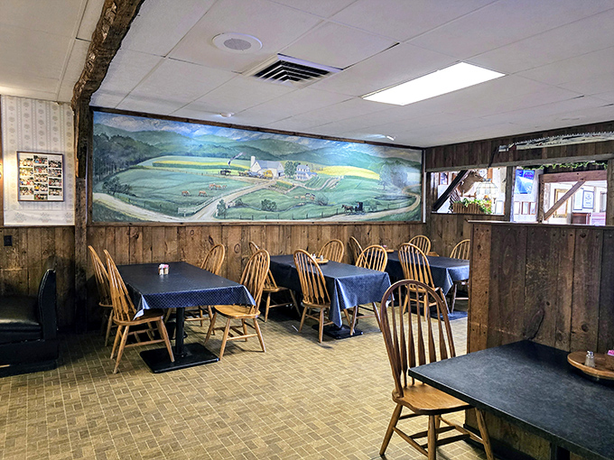 Wooden paneling and a countryside mural create a cozy dining atmosphere where time slows down and appetites come alive.