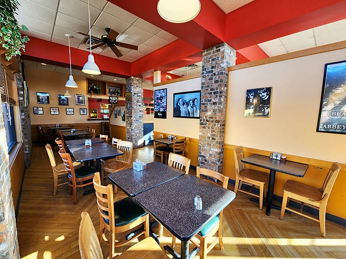 Warm wooden tones meet exposed brick columns in this cozy dining area, where Beatles memorabilia creates an atmosphere that's both nostalgic and inviting.