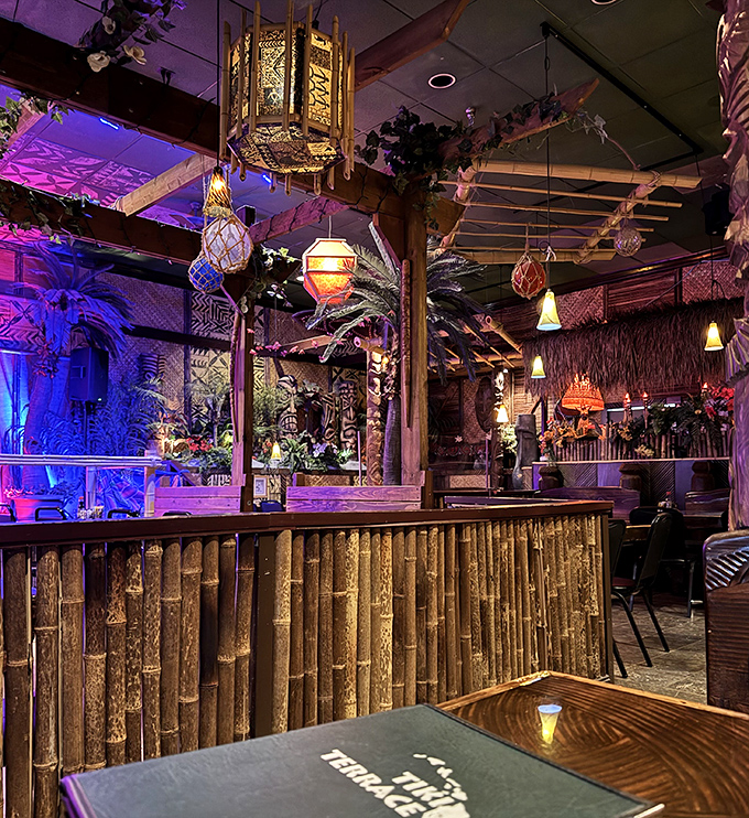 Hanging lanterns cast enchanting shadows across the bamboo bar, where tropical concoctions are mixed with island flair and mainland precision.