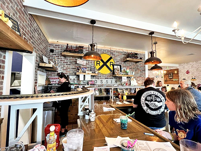 Exposed brick walls and vintage railroad memorabilia create a cozy atmosphere where nostalgia meets comfort food in perfect harmony.