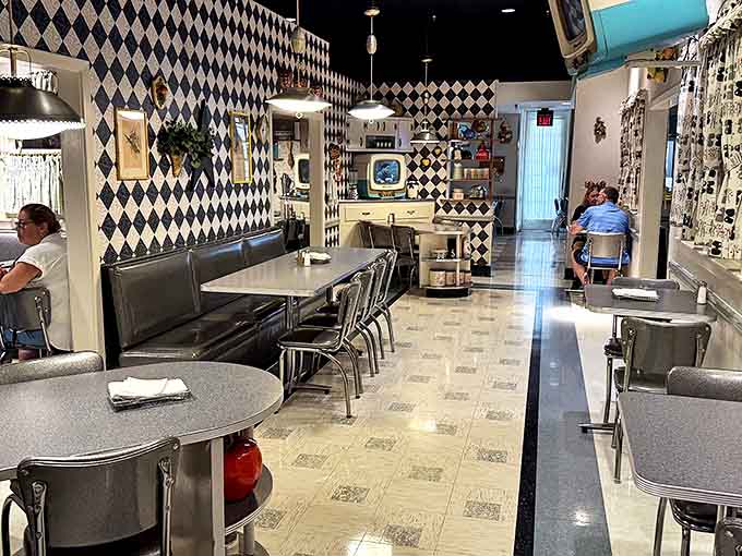Looking down from the mezzanine reveals a carefully choreographed dance of furniture styles spanning centuries and continents.