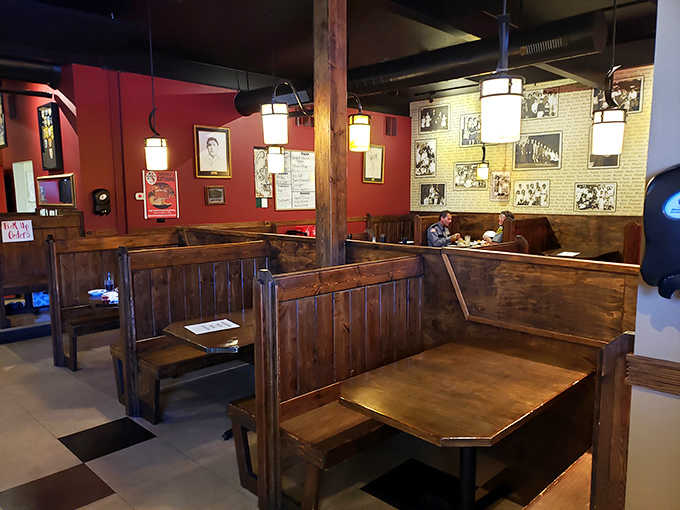 Wooden booths create intimate dining spaces where countless family stories have unfolded over plates of pasta and bottles of Chianti through the decades.