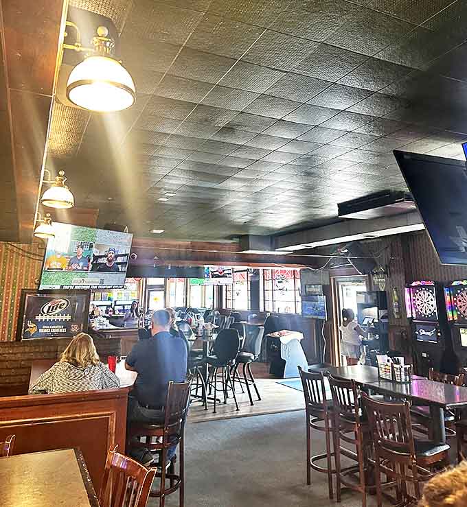 Inside Woody's, the warm glow of vintage lighting creates that "everybody knows your name" atmosphere where conversations flow as freely as the beer.