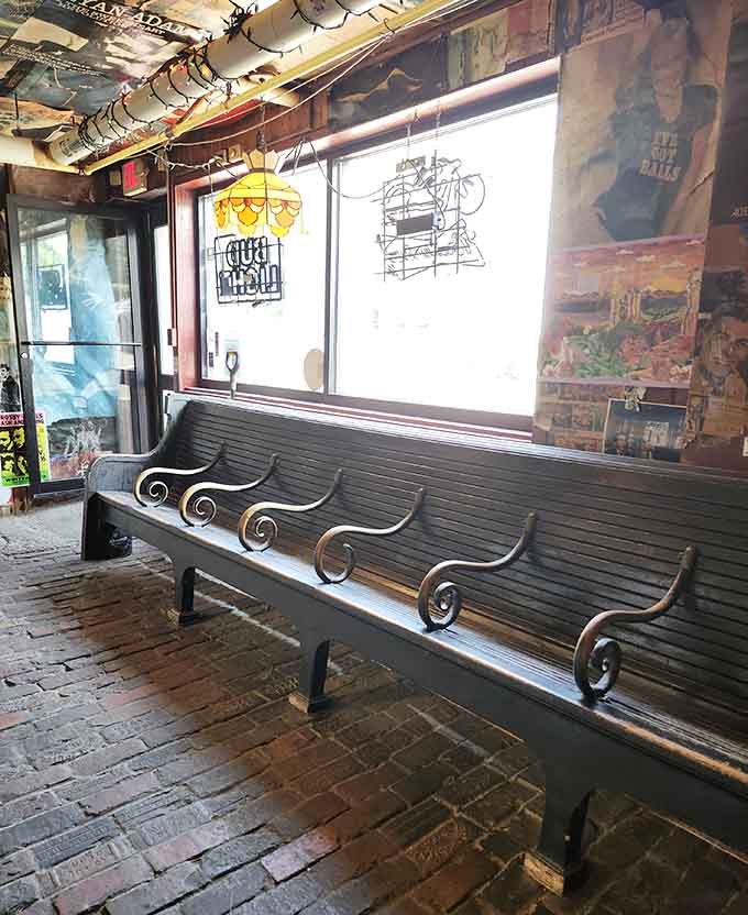 Wooden bench seating and brick floors create that perfect "been here forever" vibe where comfort trumps pretension every time.