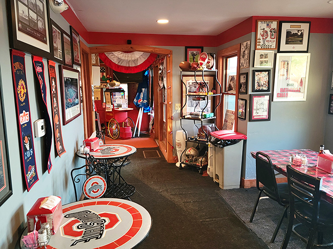 Step inside to discover walls adorned with Ohio State memorabilia, where scarlet and gray reign supreme in this cozy train car haven.