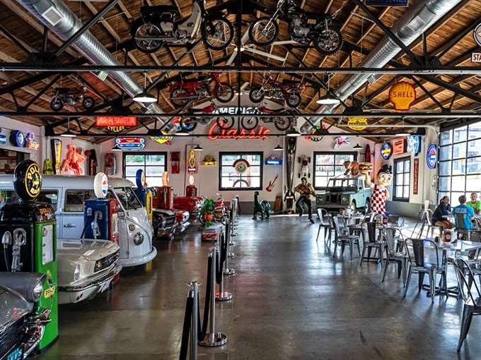 Step inside to automotive heaven! Vintage motorcycles suspended from wooden beams while classic cars create the world's coolest dining companions.