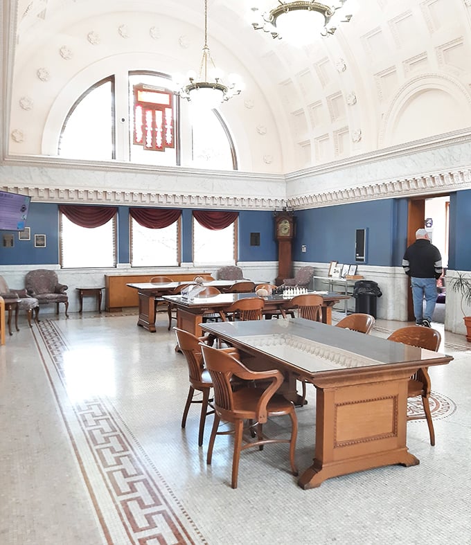 The main reading room's soaring ceiling and elegant blue walls create an atmosphere where even restless readers find themselves settling in for hours.