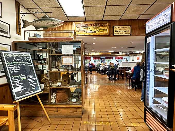 Wood-paneled walls adorned with mounted fish create an authentic nautical atmosphere that transports diners to simpler times.