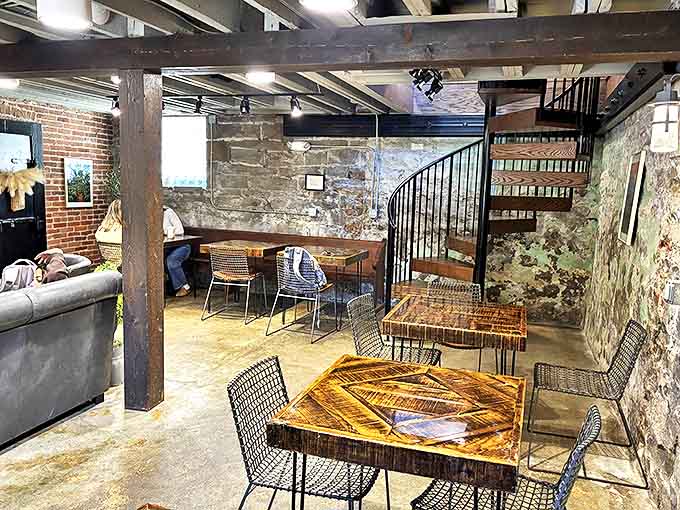 Exposed beams, stone walls, and a spiral staircase create an atmosphere where your latte tastes like it has a backstory.