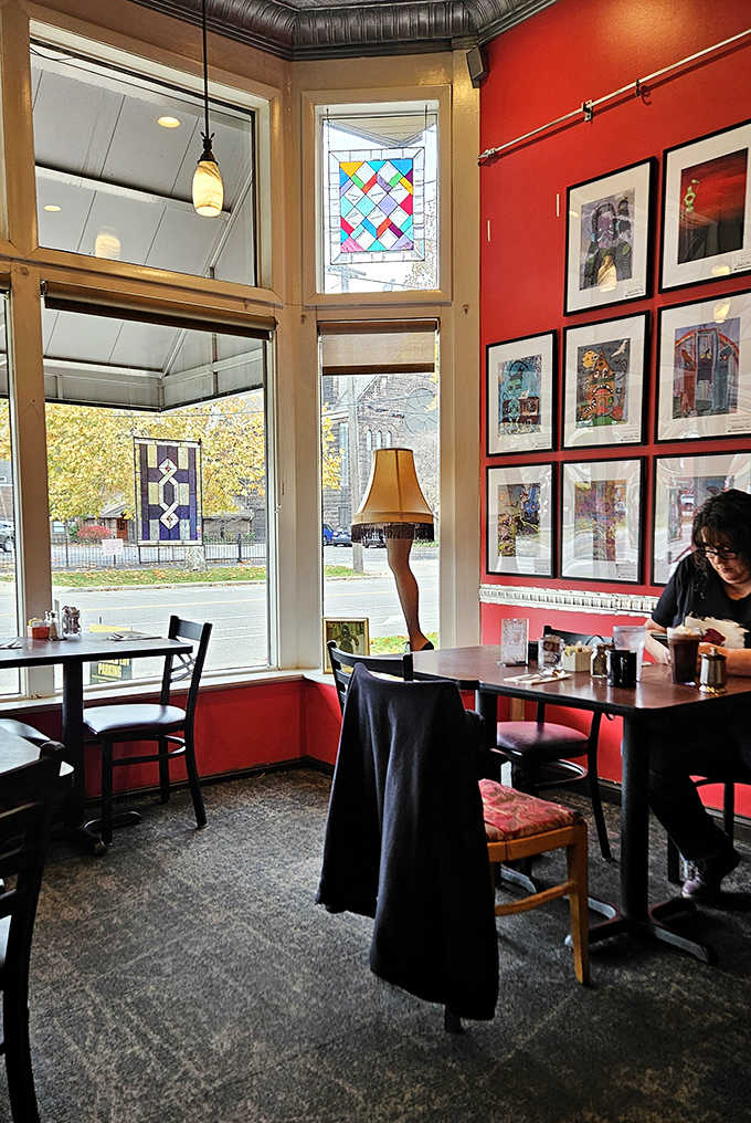 Colorful stained glass windows filter morning light across tables where regulars linger over coffee, creating a warm, artistic vibe.