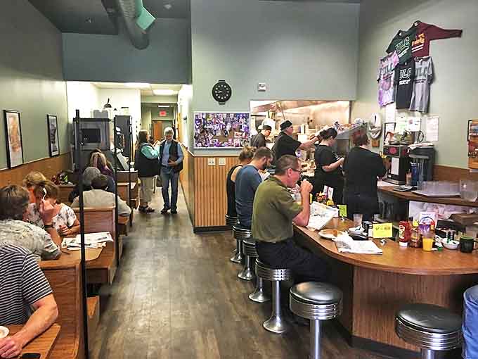 Inside Uncle Loui's, the counter seating invites solo diners while tables welcome groups to this breakfast haven where community happens naturally.