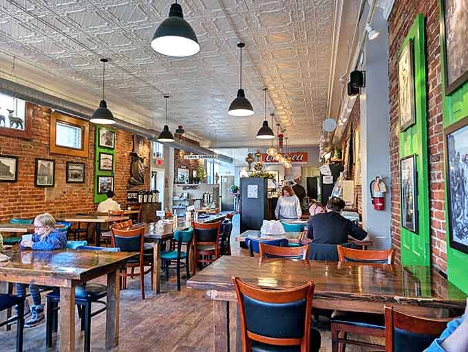 Inside Zou Zou's, exposed brick meets pressed tin ceilings while patrons savor moments of connection over steaming cups and delectable plates.