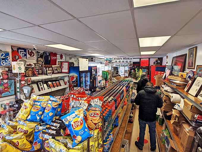 Inside this treasure trove of snacks and local products, the real magic happens behind that counter where sandwich dreams become towering, meat-filled reality.