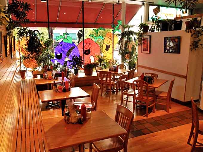 Interior: Sunlight streams through windows illuminating wooden tables and whimsical vegetable murals, creating the perfect backdrop for memorable meals and conversations.