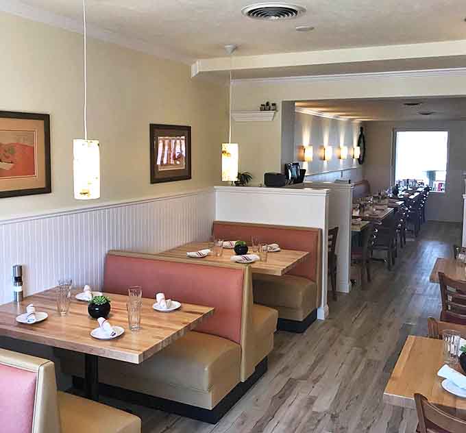 Warm wood tones meet blush upholstery in this perfectly balanced space where comfort meets style without trying too hard.