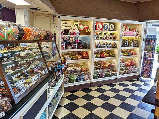 Stepping inside reveals a wonderland of sweets with classic black and white checkered floors and display cases filled with handcrafted chocolates.