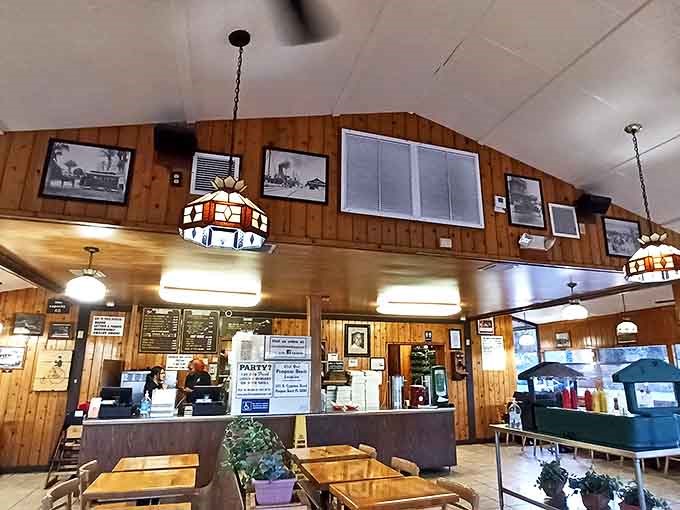 Wood-paneled walls and vintage pendant lights create a time capsule atmosphere where conversations flow as freely as the milkshakes.
