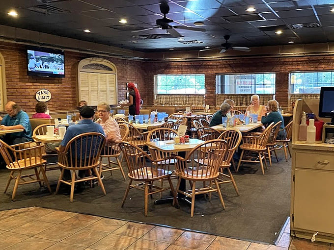Wooden chairs and exposed brick create a cozy atmosphere where trains and good times share the spotlight beautifully.