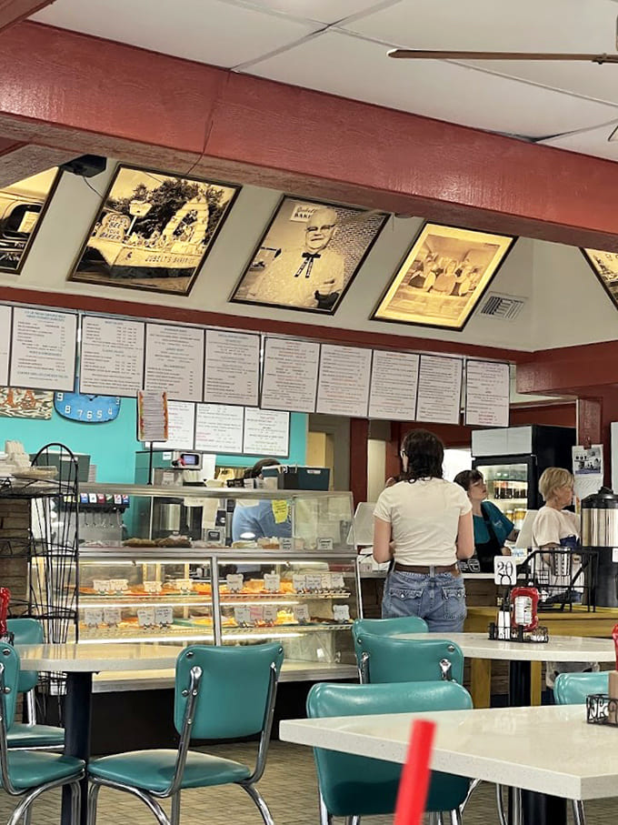 Step inside and you're greeted by vintage charm meets modern comfort, where turquoise chairs and nostalgic photos create the perfect backdrop for serious eating.