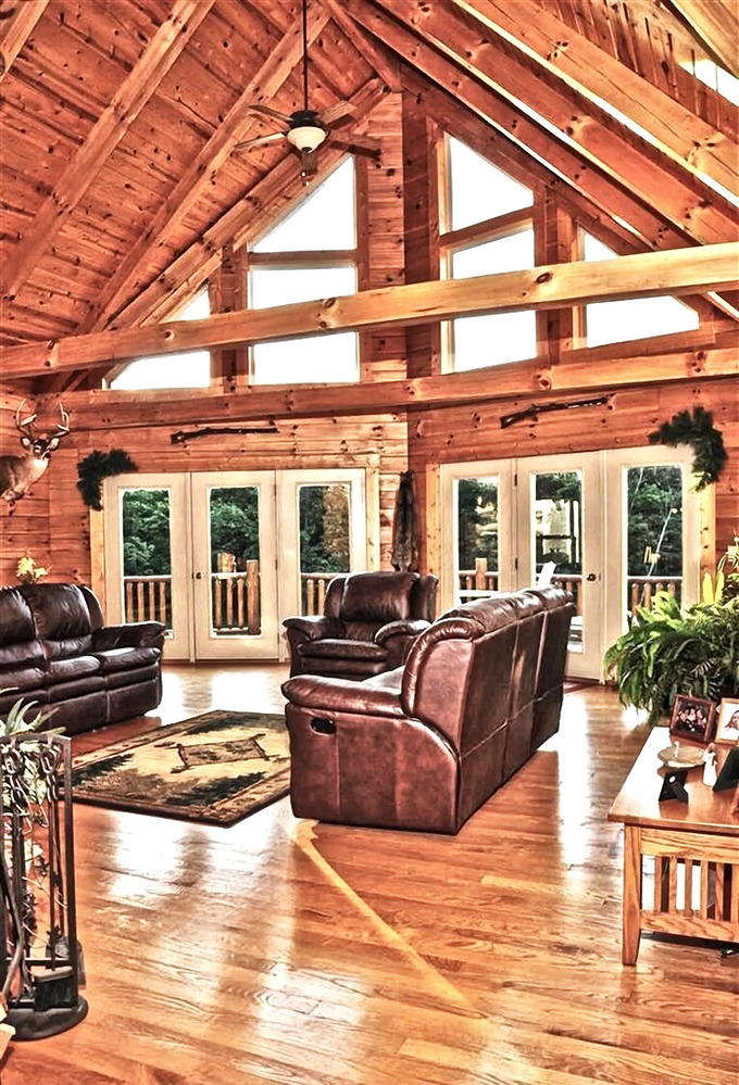 Soaring ceilings, warm wood tones, and leather furnishings create a great room that somehow manages to feel both grand and cozy simultaneously.