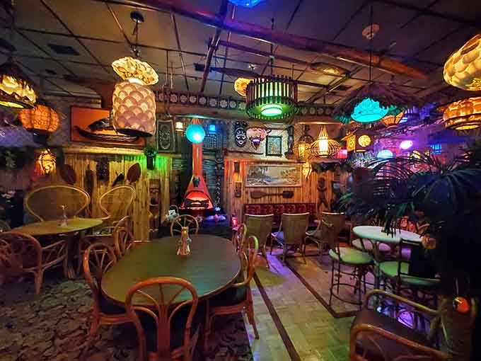 Step inside and be transported to a Polynesian dream world. Intricate tiki lamps cast a warm glow over bamboo furnishings, while thatched roofing completes the immersive island experience.