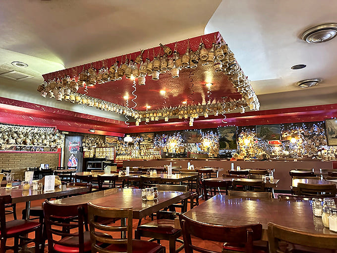 Hundreds of straw-wrapped Chianti bottles dangle from the ceiling, each signed by loyal customers creating a canopy of memories.