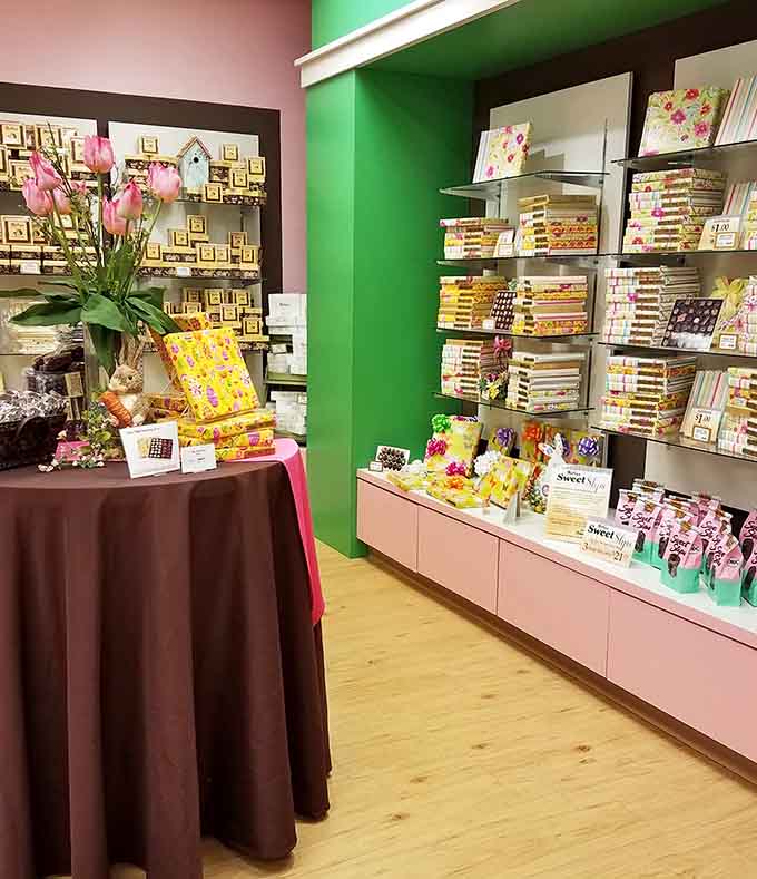 Chocolate paradise awaits! Rows of handcrafted confections glisten under soft lighting, each variety more tempting than the last.