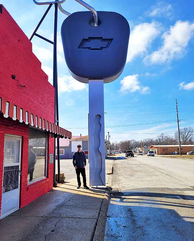 A visitor provides scale next to the massive Chevrolet key &ndash; suddenly your keychain doesn't seem so impressive anymore.