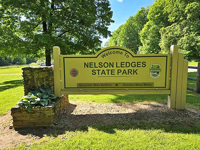 The welcoming gateway to adventure &ndash; Nelson Ledges State Park's sign stands proudly, promising geological wonders and forest magic beyond.