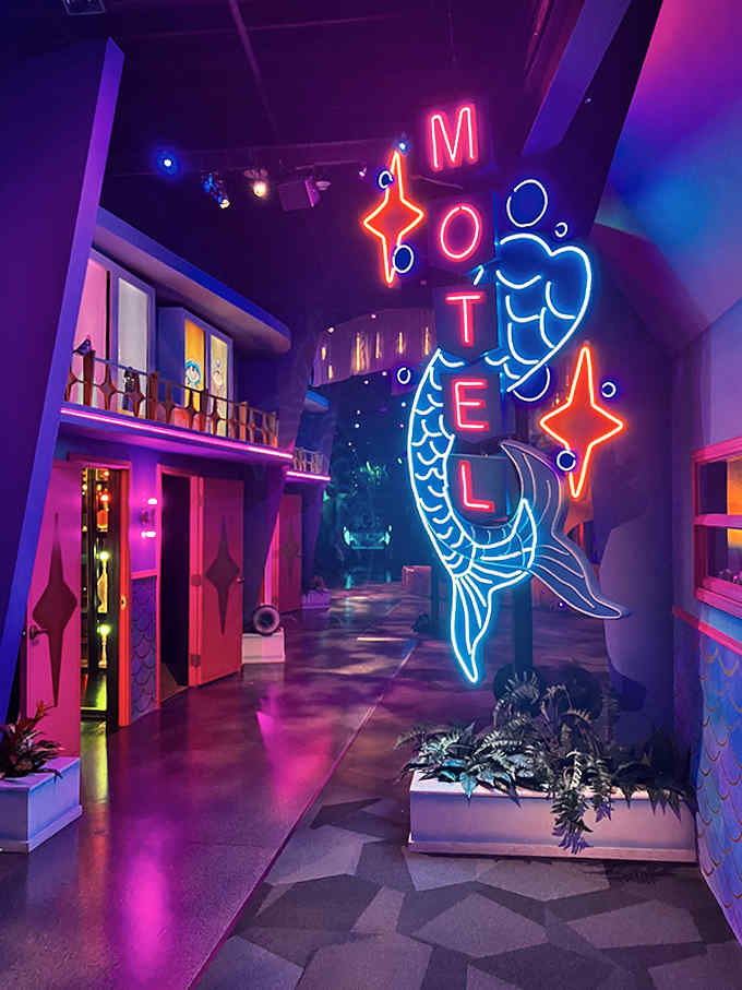 The iconic Motel sign glows with otherworldly promise &ndash; less "vacancy" and more "your brain has vacancies we're about to fill."