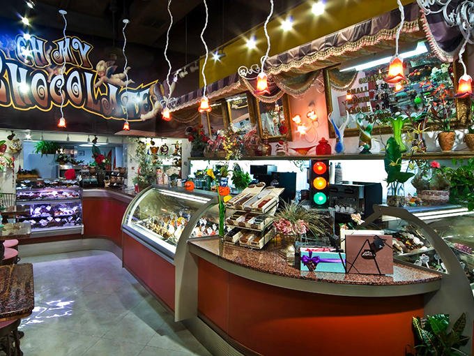 Inside, the Willy Wonka-meets-toy-store interior dazzles with colorful displays under "Gaudy Chocolates" signage that perfectly captures the shop's playful spirit.