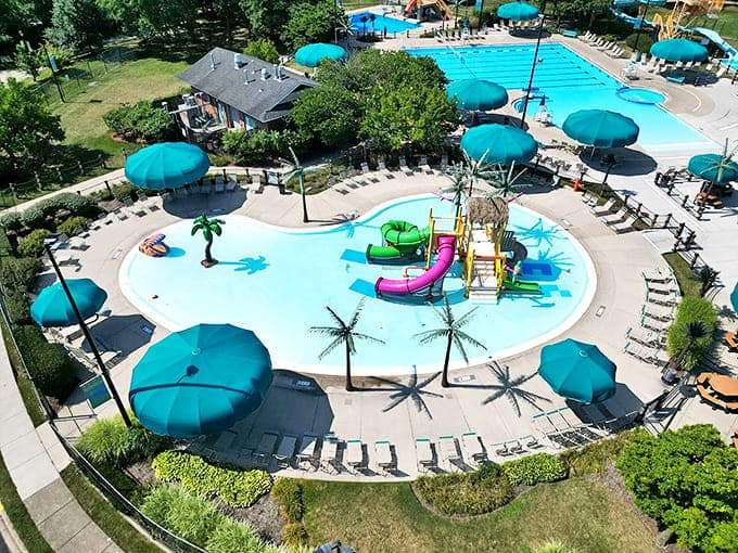From above, the waterpark resembles a blue oasis, with teal umbrellas dotting the landscape like tropical mushrooms after rain.