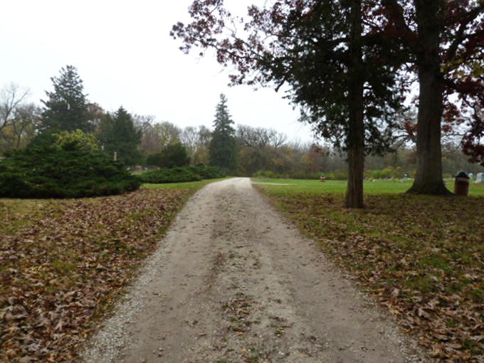 The winding path beckons visitors deeper into Aux Sable's grounds, where history and mystery await around every gentle curve.