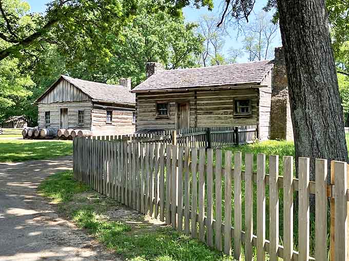 The reconstructed village spreads across rolling prairie, each log building telling stories of 1830s pioneer determination and daily survival.