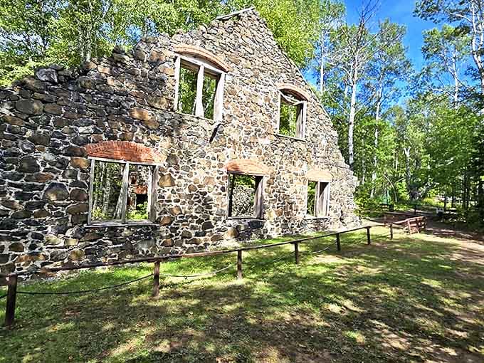 Stone walls stand defiant against time, whispering tales of industrial might that once echoed through these Keweenaw forests.