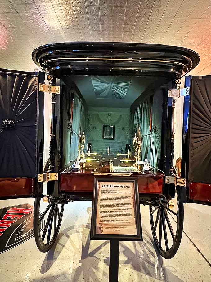 Step inside the 1912 Riddle Hearse and glimpse funeral luxury from a bygone era, complete with silk draperies and ornate detailing.
