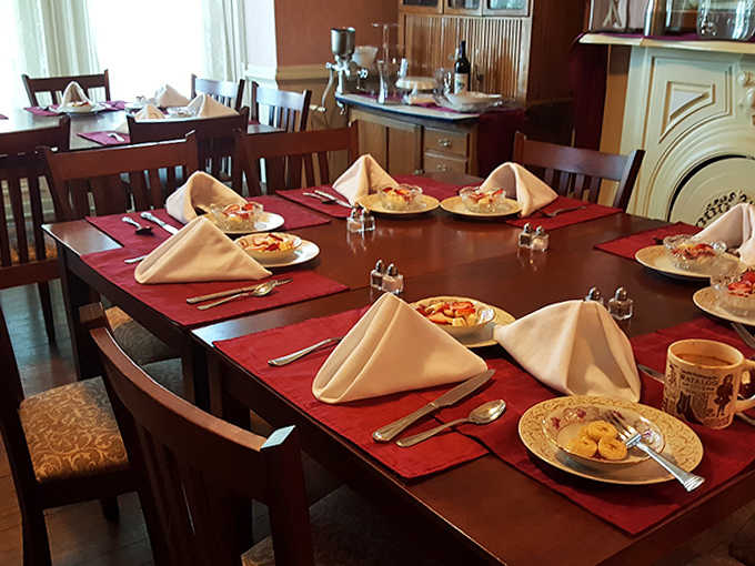 Breakfast tables set with care, waiting to host morning conversations over fresh pastries and strong coffee.