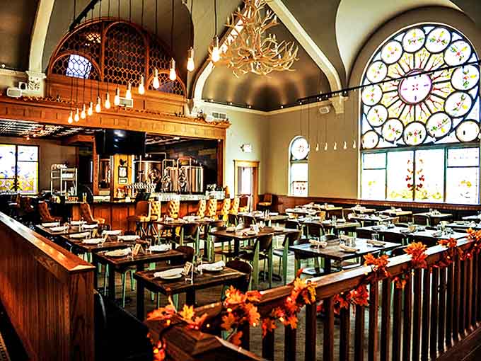 Soaring ceilings and wooden beams create a cathedral-like dining experience, proving that good beer can indeed be a religious experience.
