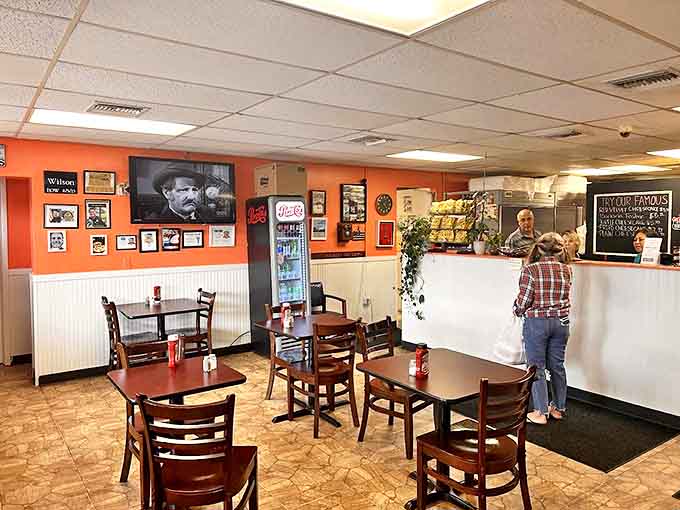 Warm orange walls, vintage photos, and cozy seating create the perfect backdrop for what many consider Florida's finest cheesesteak experience.