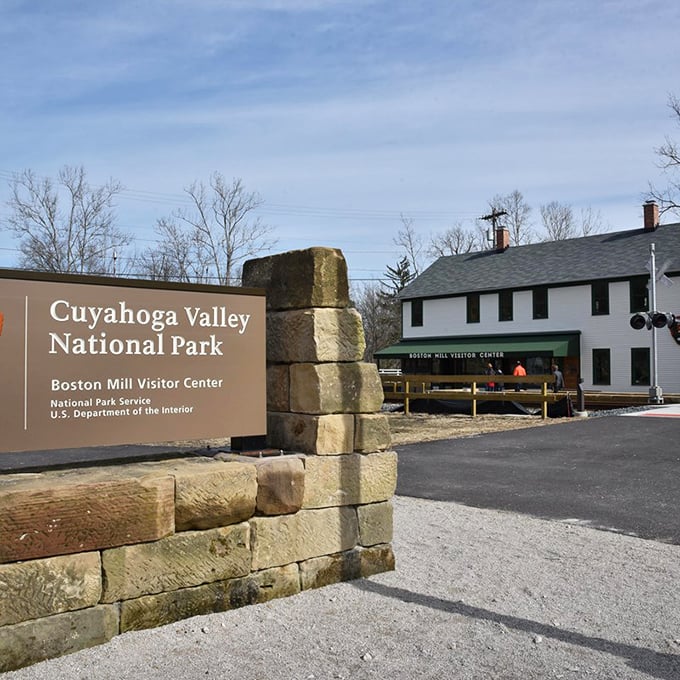 The stone entrance to Cuyahoga Valley National Park welcomes visitors with rustic charm, nature's playground awaiting just beyond.