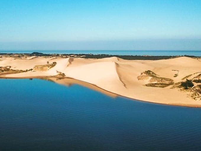 Nature's perfect contradiction: massive sand dunes rise dramatically alongside Silver Lake, forming an otherworldly landscape that defies Midwestern expectations.