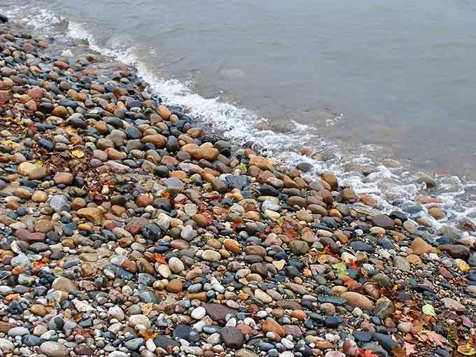 Nature's mosaic &ndash; smooth stones in every imaginable hue create a shoreline symphony that changes with each gentle wave.