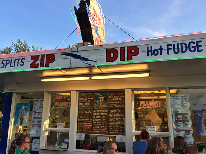 As evening approaches, Zip Dip's illuminated storefront beckons ice cream lovers with promises of banana splits, soft serve, and hot fudge cakes.