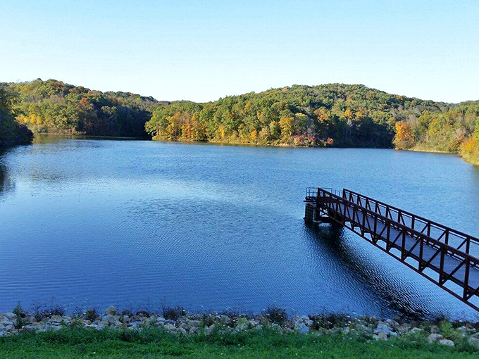 Strouds Run State Park offers a serene escape just minutes from downtown Athens, where a peaceful dock extends into crystal-clear waters surrounded by rolling hills.