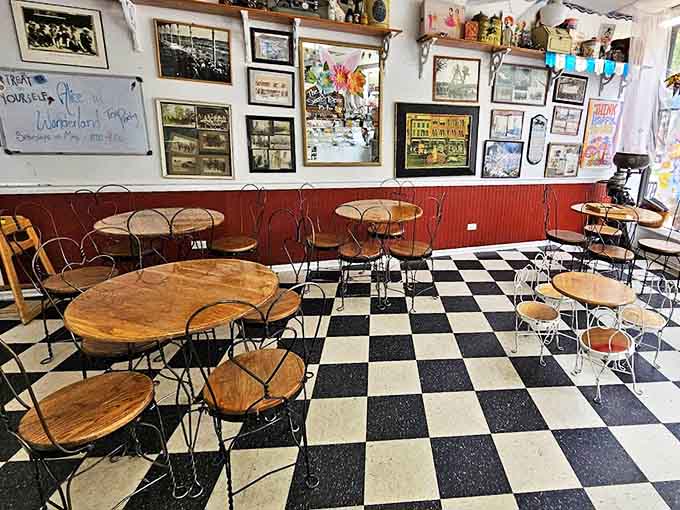 Black and white checkered floors meet warm wooden tables in this time capsule of Americana where every seat promises a journey to simpler times.