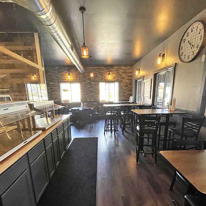 Step inside to discover a cozy interior where industrial-chic meets warm ambiance &ndash; those pendant lights aren't just pretty, they're illuminating pizza perfection.