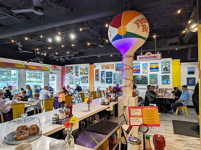 Inside, a whimsical beach ball water tower hangs from the ceiling while diners enjoy their meals in a space that screams "Florida fun."